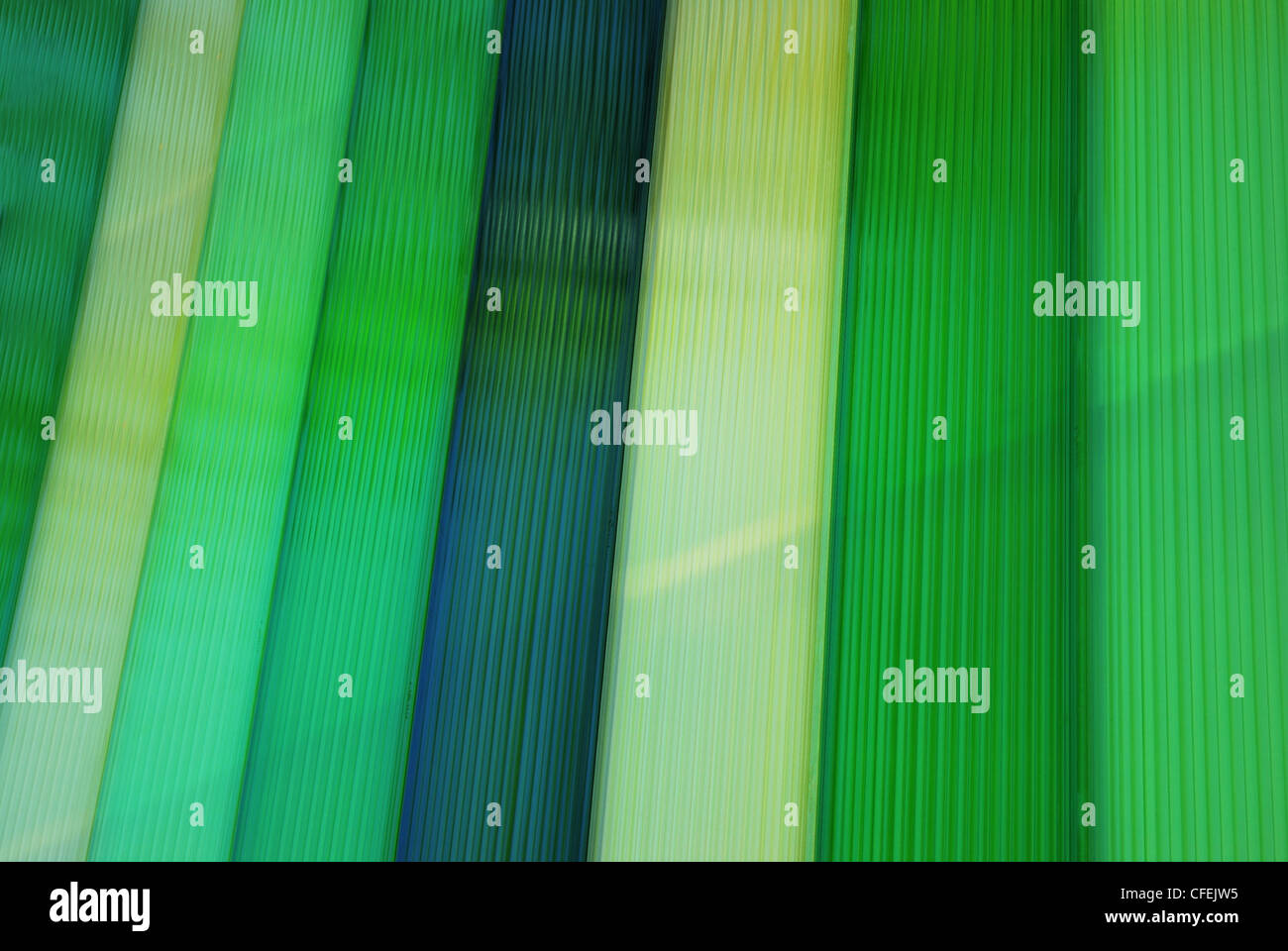 Different green plastic stripes as a background Stock Photo - Alamy