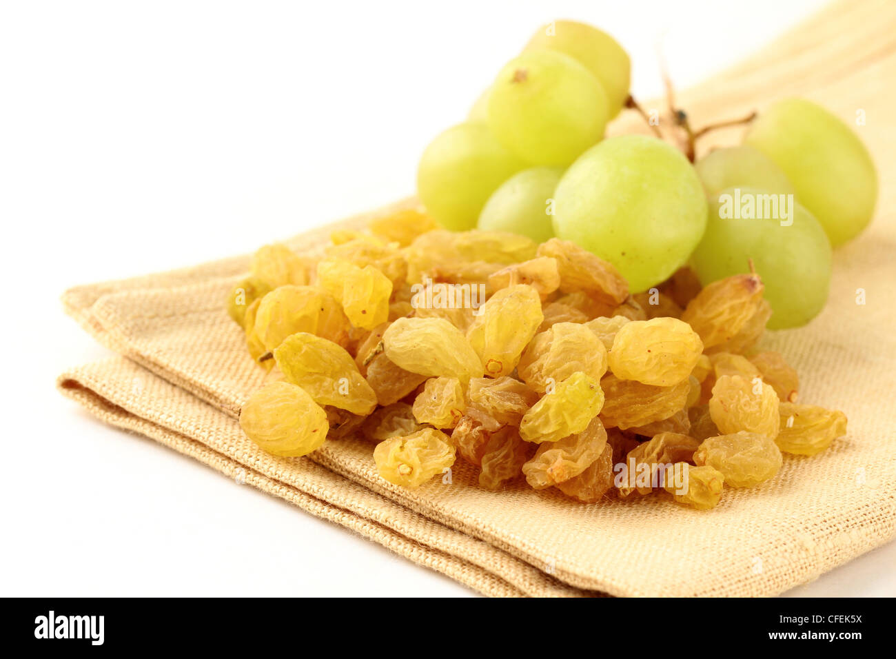 white raisins and fresh grapes on white background Stock Photo - Alamy
