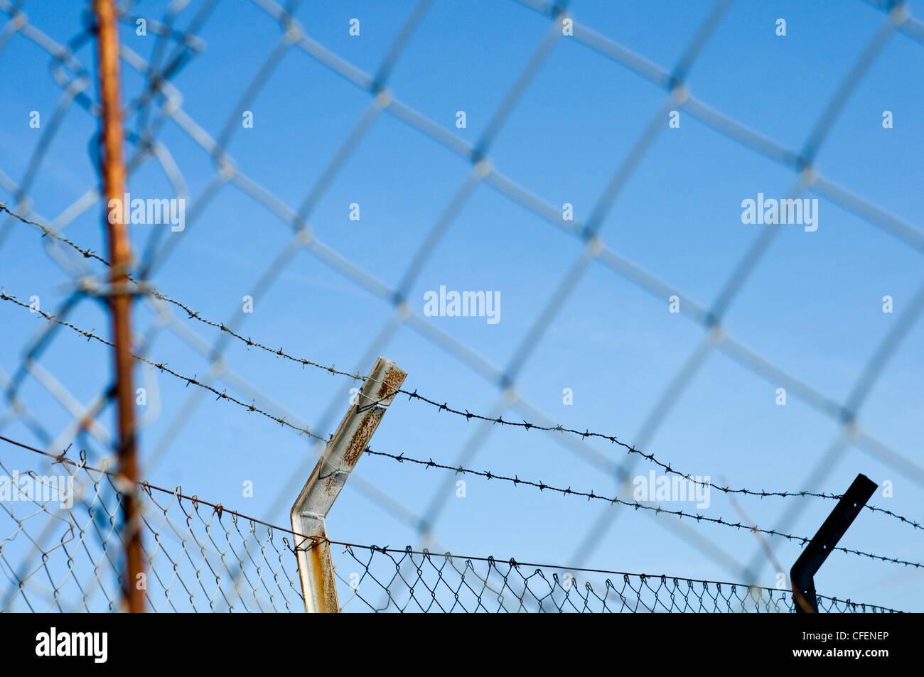 A section of security fencing and barbed wire Stock Photo - Alamy