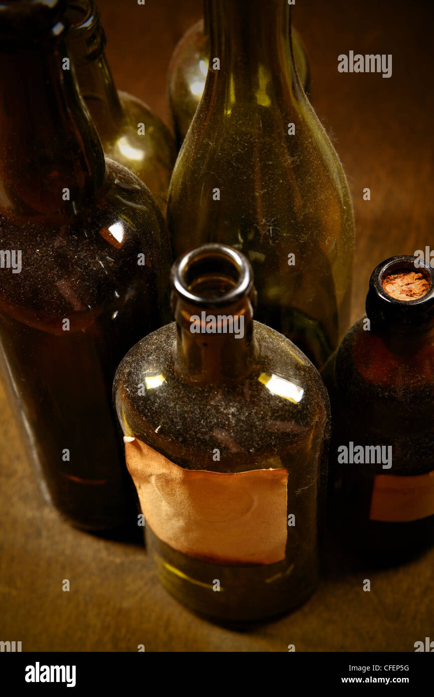 Old tagged bottles with transparent liquid close-up Stock Photo - Alamy