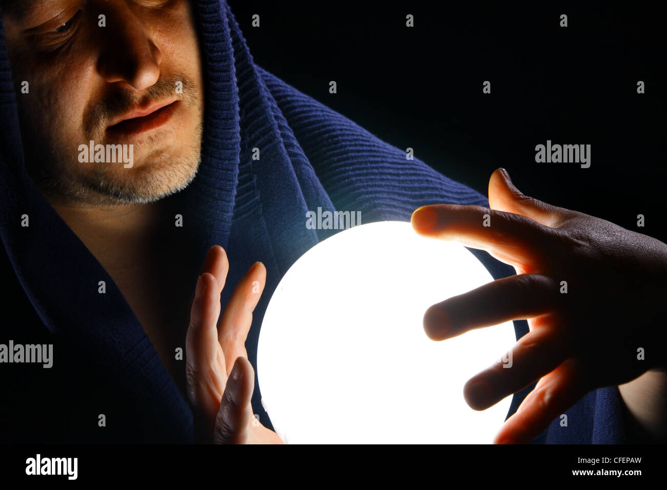 Wizard with glowing magical ball Stock Photo - Alamy