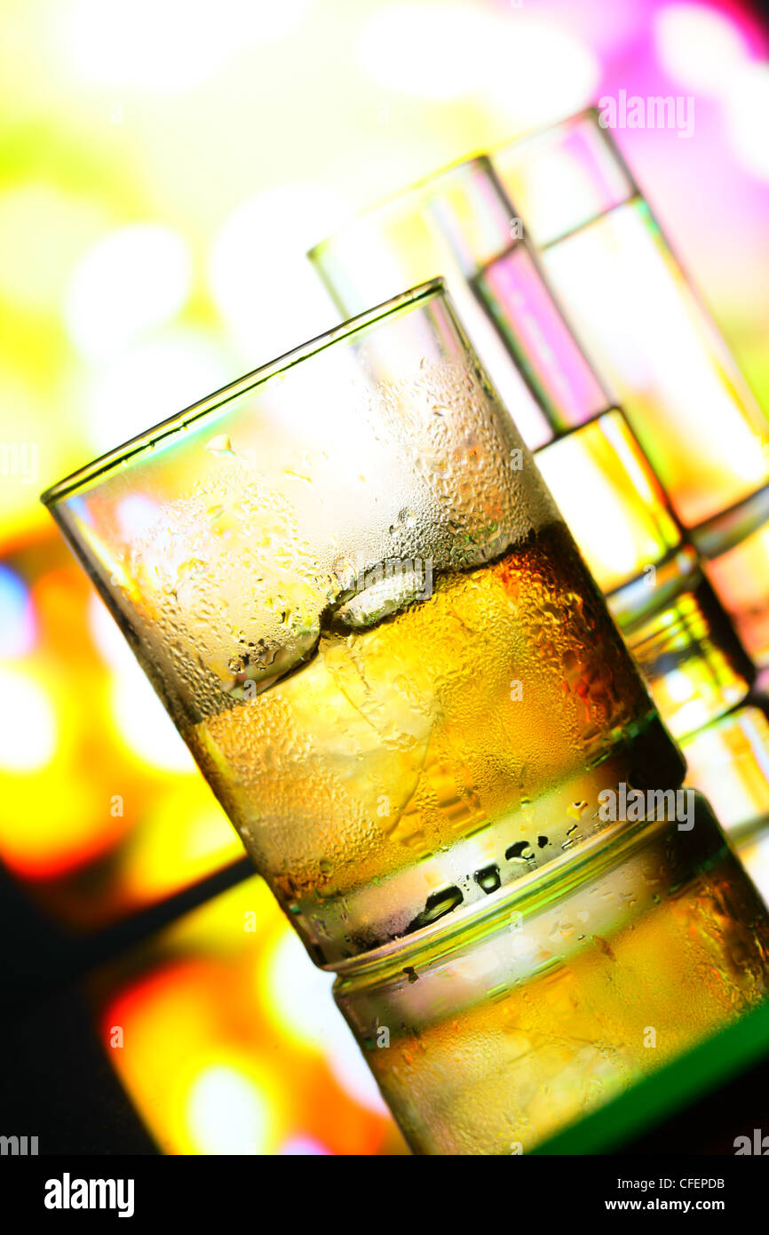 Glasses of alcohol closeup over colorful background Stock Photo - Alamy