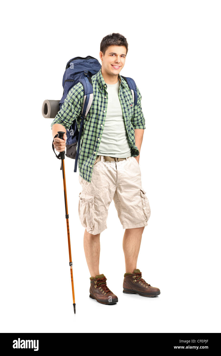 Full length portrait of a hiker with backpack and hiking poles posing ...