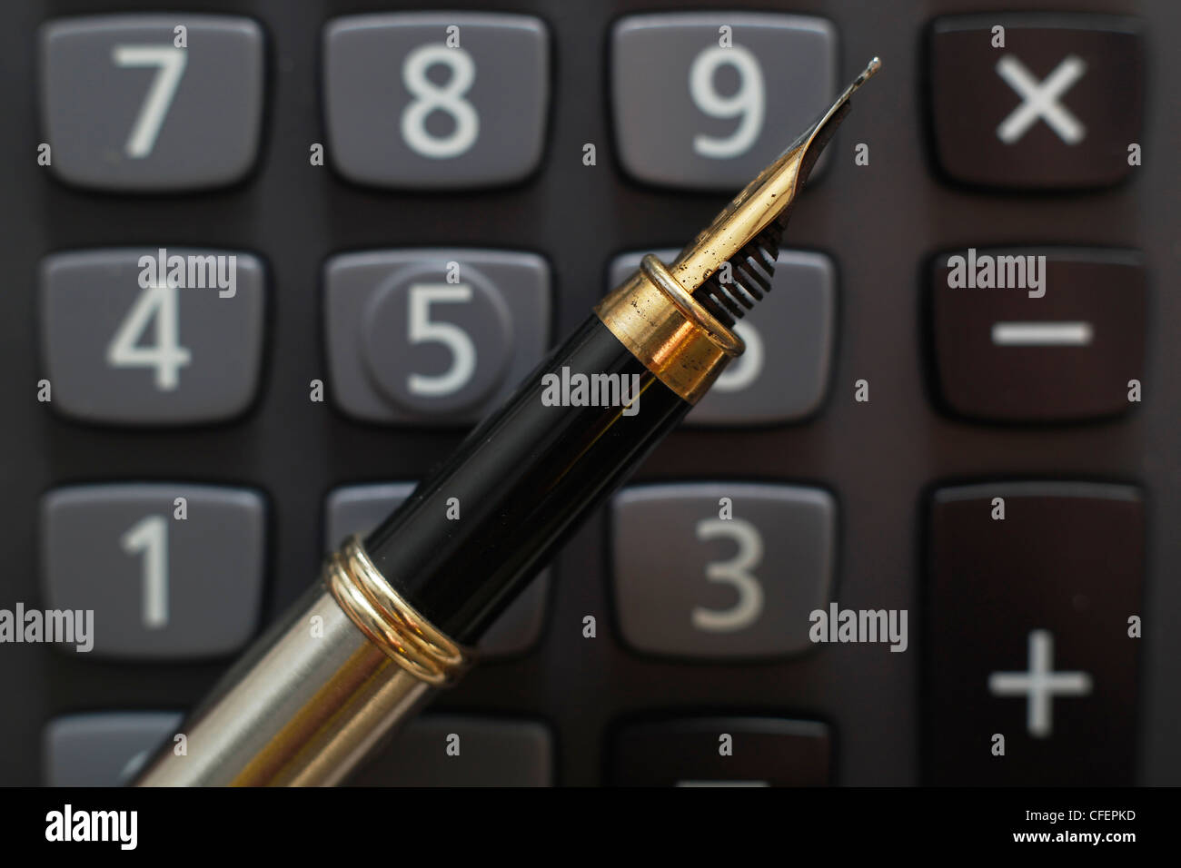 Business office image of ink pen with gold nib and calculator Stock ...