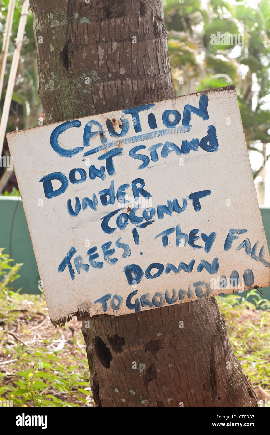 Warning sign under a coconut tree in Kauai, Hawaii Stock Photo - Alamy