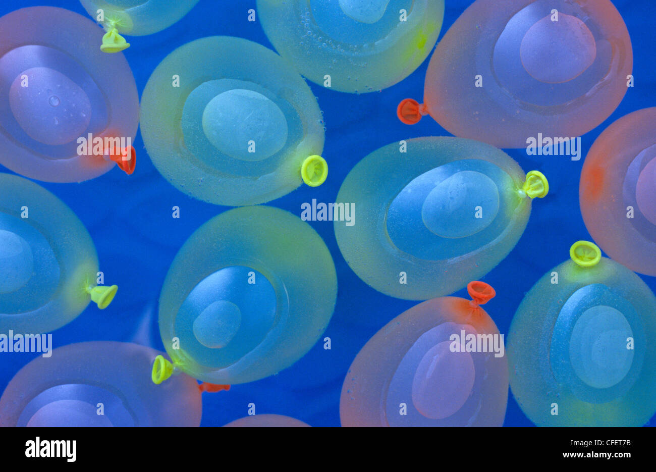 Water balloons in pool floating, yellow and red balloons patterns ...