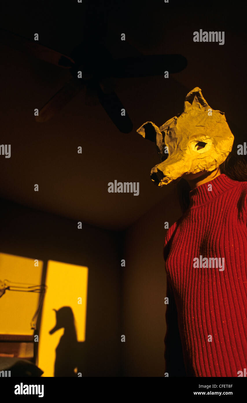 Teen girl wearing a wolf mask inside a house portrait Stock Photo - Alamy