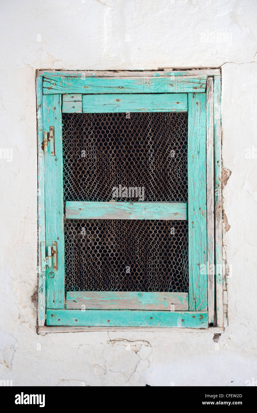 Old turquoise wooden window with chicken wire screen Stock Photo - Alamy