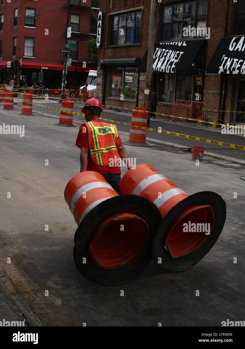 Workman dragging devices to block street, Brooklyn, New York Stock ...