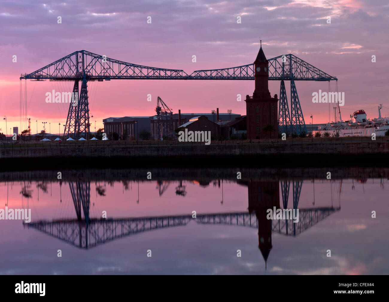 Middlesbrough bridge at night on the river Tees with a pink sky and ...