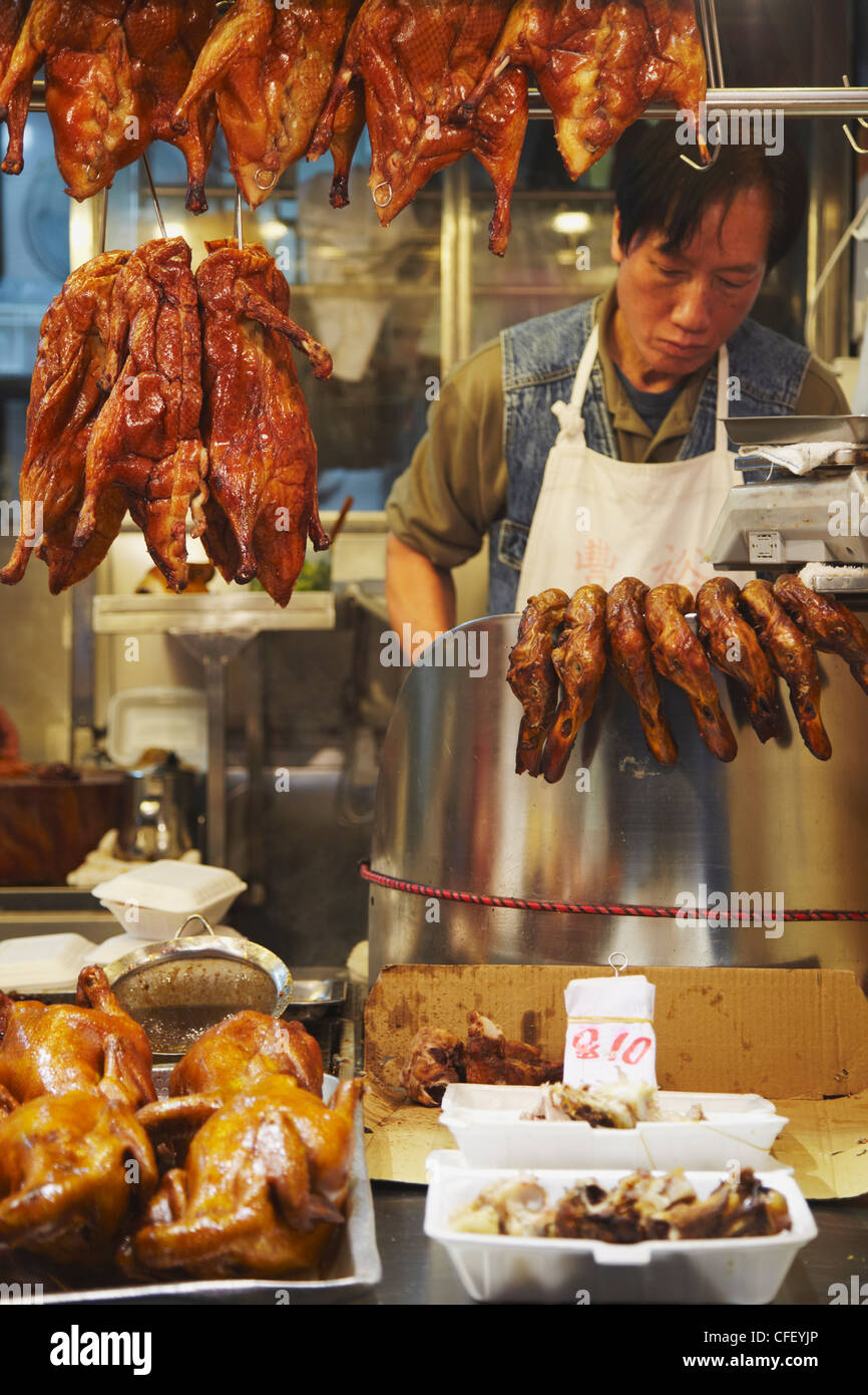 Man selling roast chicken and duck at market, Causeway Bay, Hong Kong ...