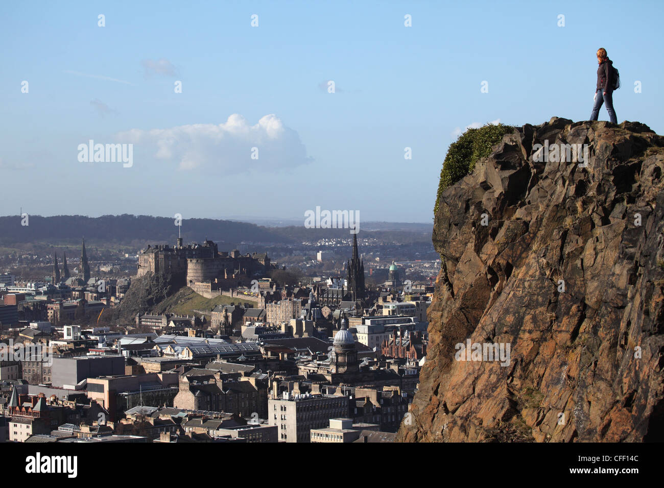 A tourist on Arthur's Seat looking towards the castle and skyline of ...