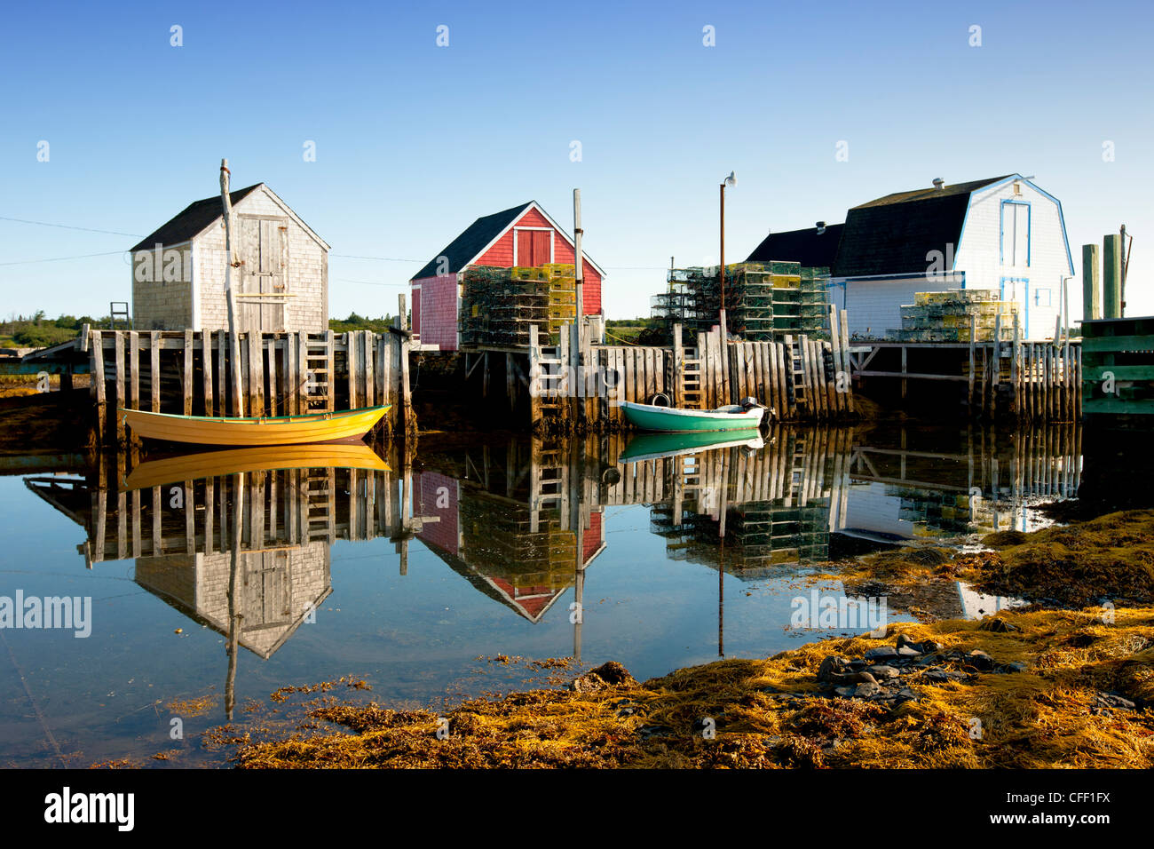 Dories reflected in water at low tide, Blue Rocks, Lunenburg, Nova ...