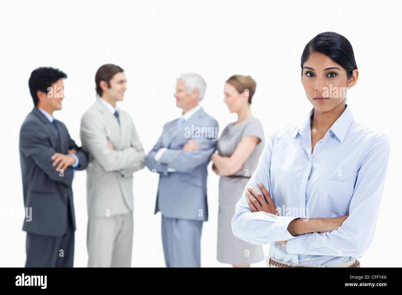 Close-up of a multicultural business team talking and a serious woman ...