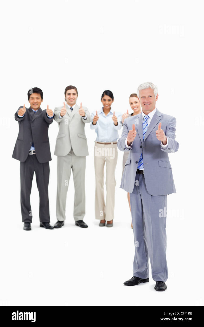Multicultural business team with their thumbs-up with a mature man ...