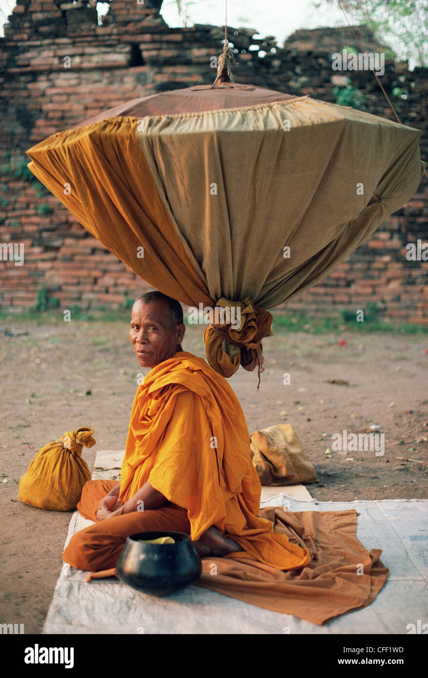 Thailand, Aytthaya, Monk Sitting Under Tree near Wat Phra Sri Samphet ...