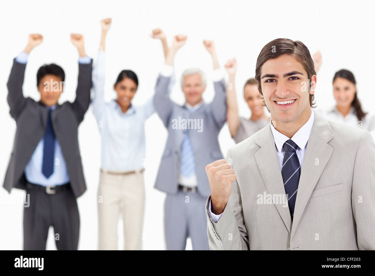 Close-up of a multicultural business team raising their arms focus on a ...