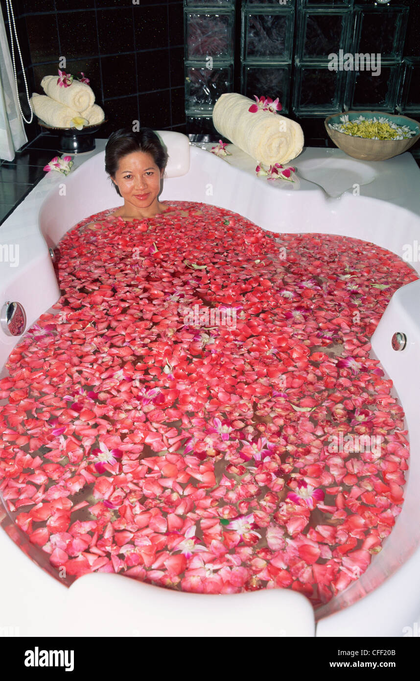 Thailand, Bangkok, Woman in Spa Bath with Rose Petal Covered Water ...