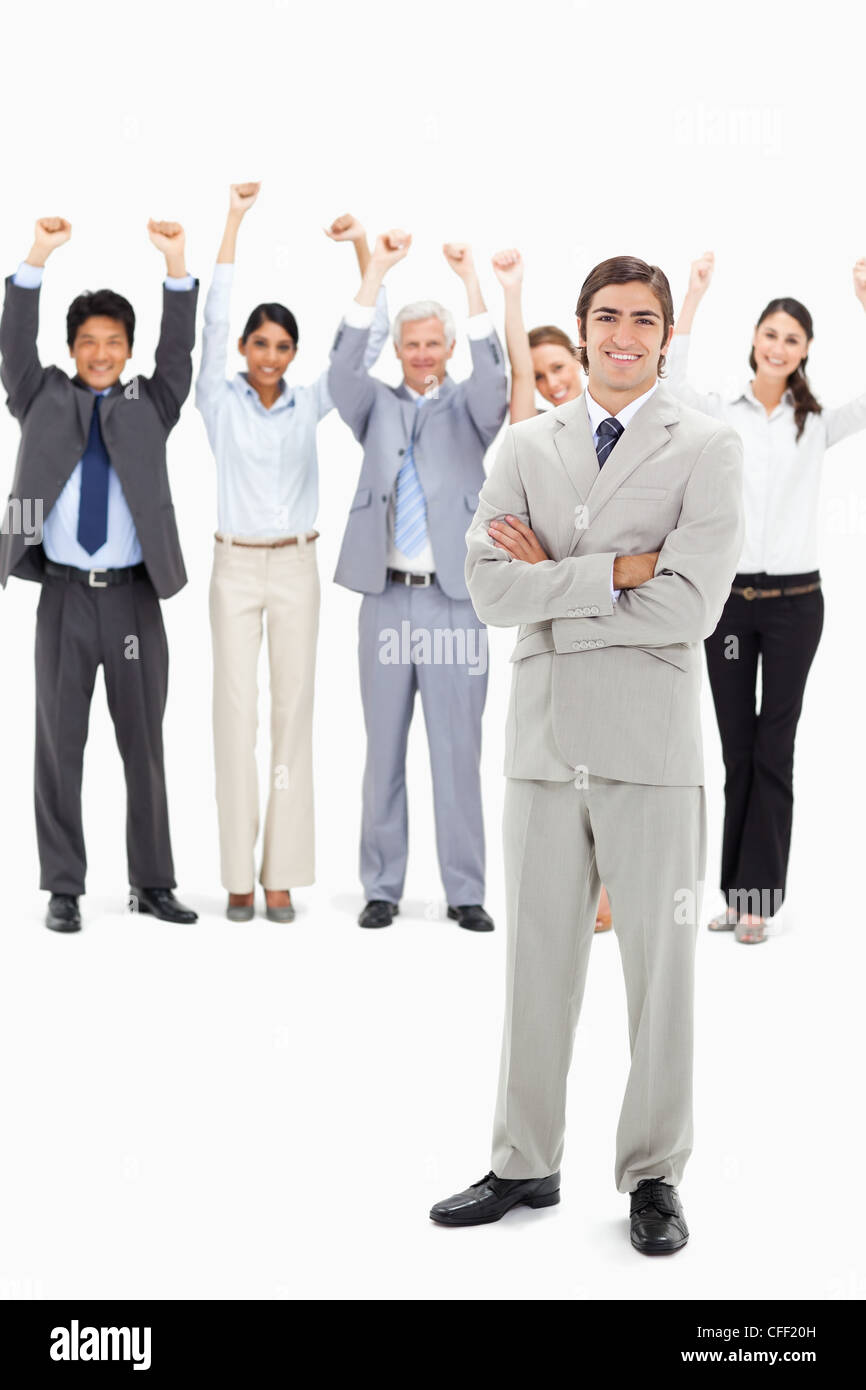 Multicultural business team raising their arms focus on a man with his ...
