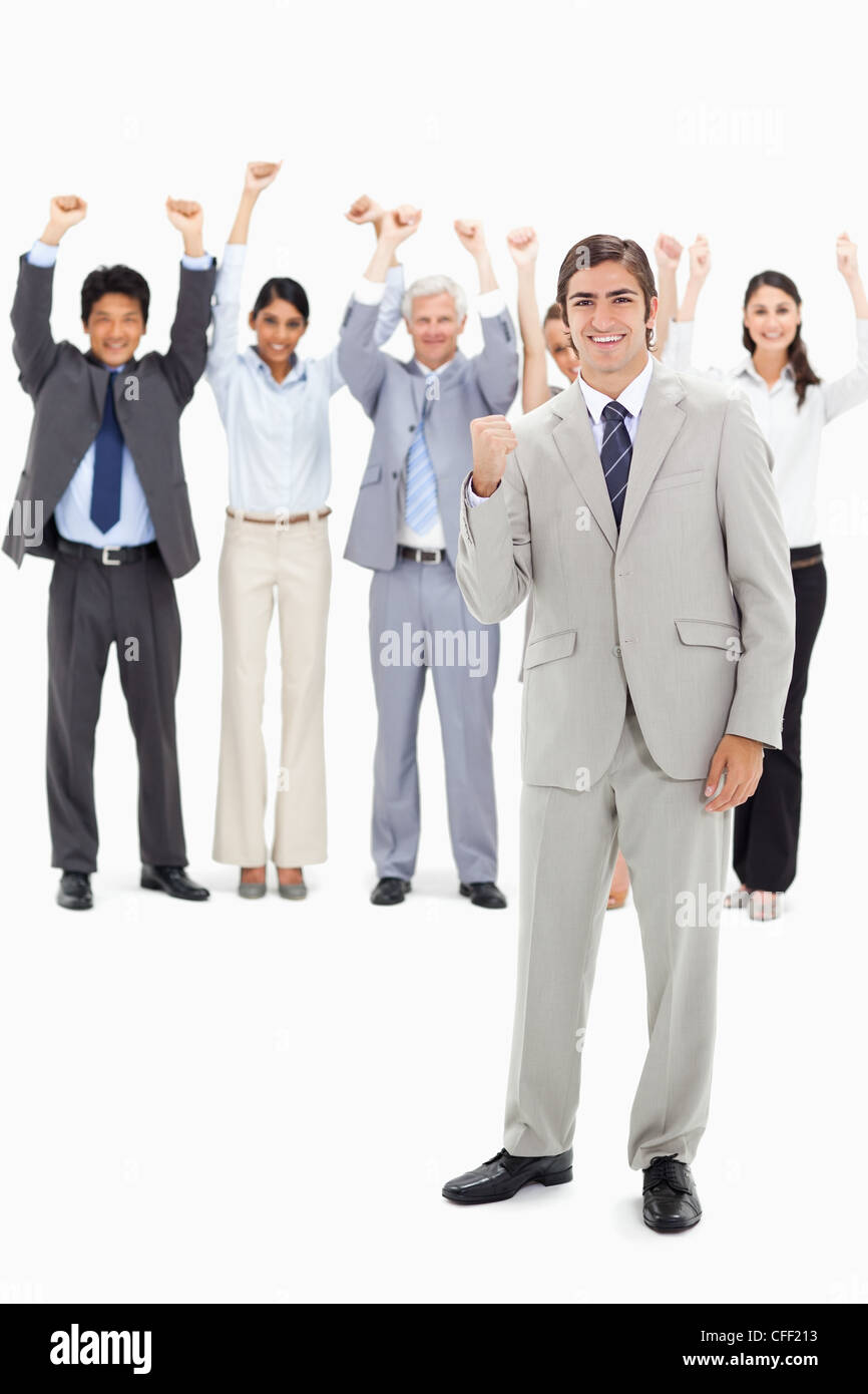 Multicultural business team raising their arms focus on a man clenching ...