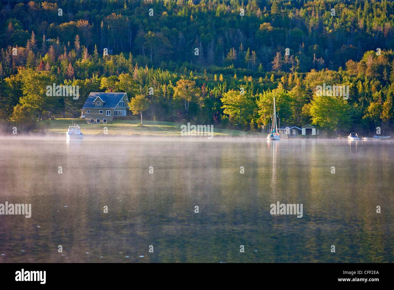 View of fog lifting on Baddeck Bay, Bras D'Or Lake, Cape Breton, Nova ...