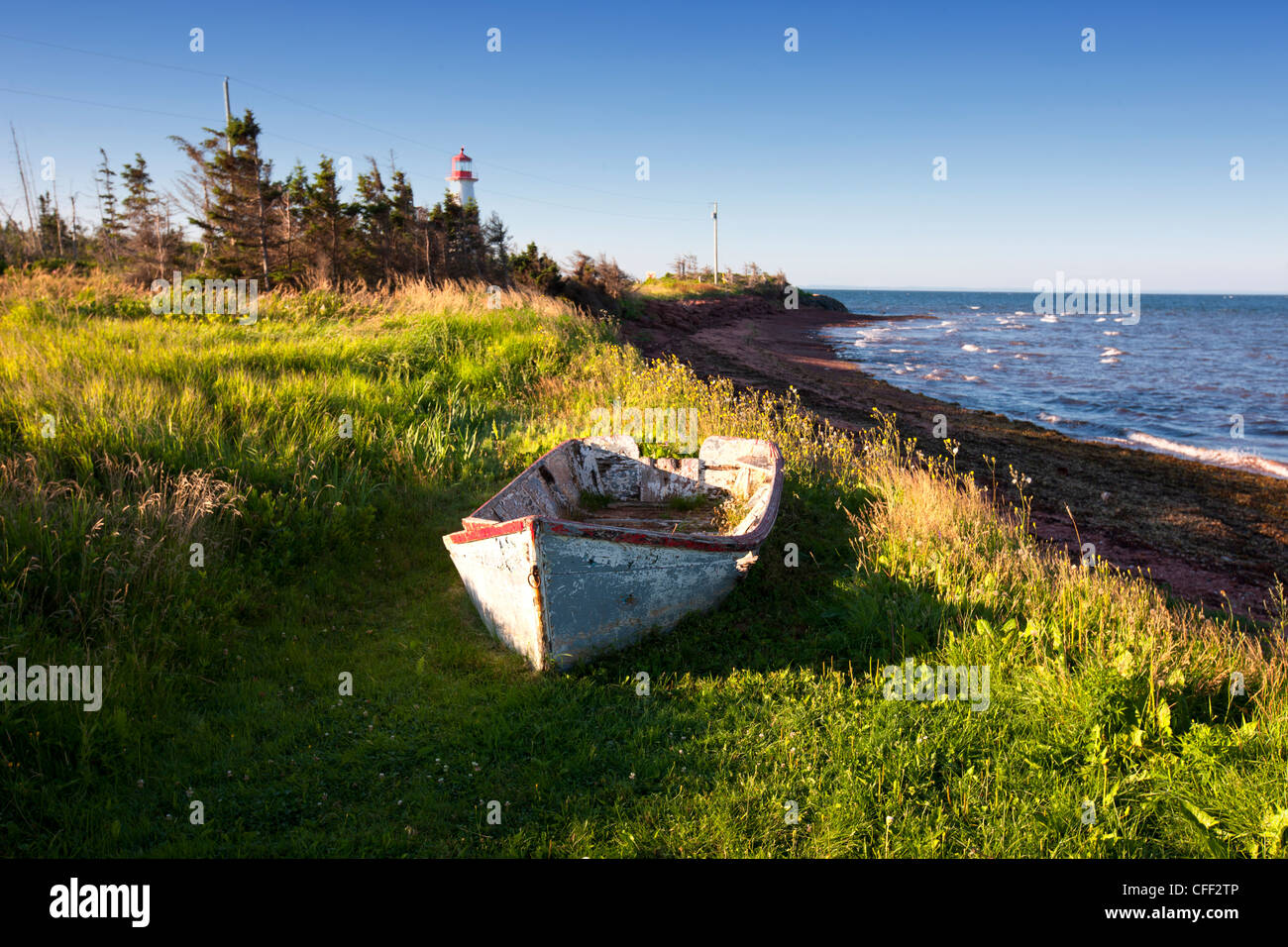 Old wooden dory in front of Point Prim Lighthouse, Prince Edward Island ...