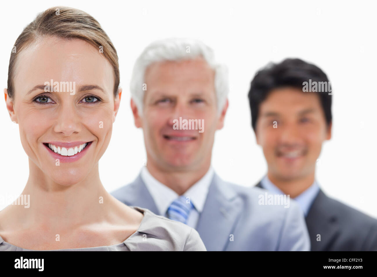 Close-up of smiling business people in a single line with focus on the ...