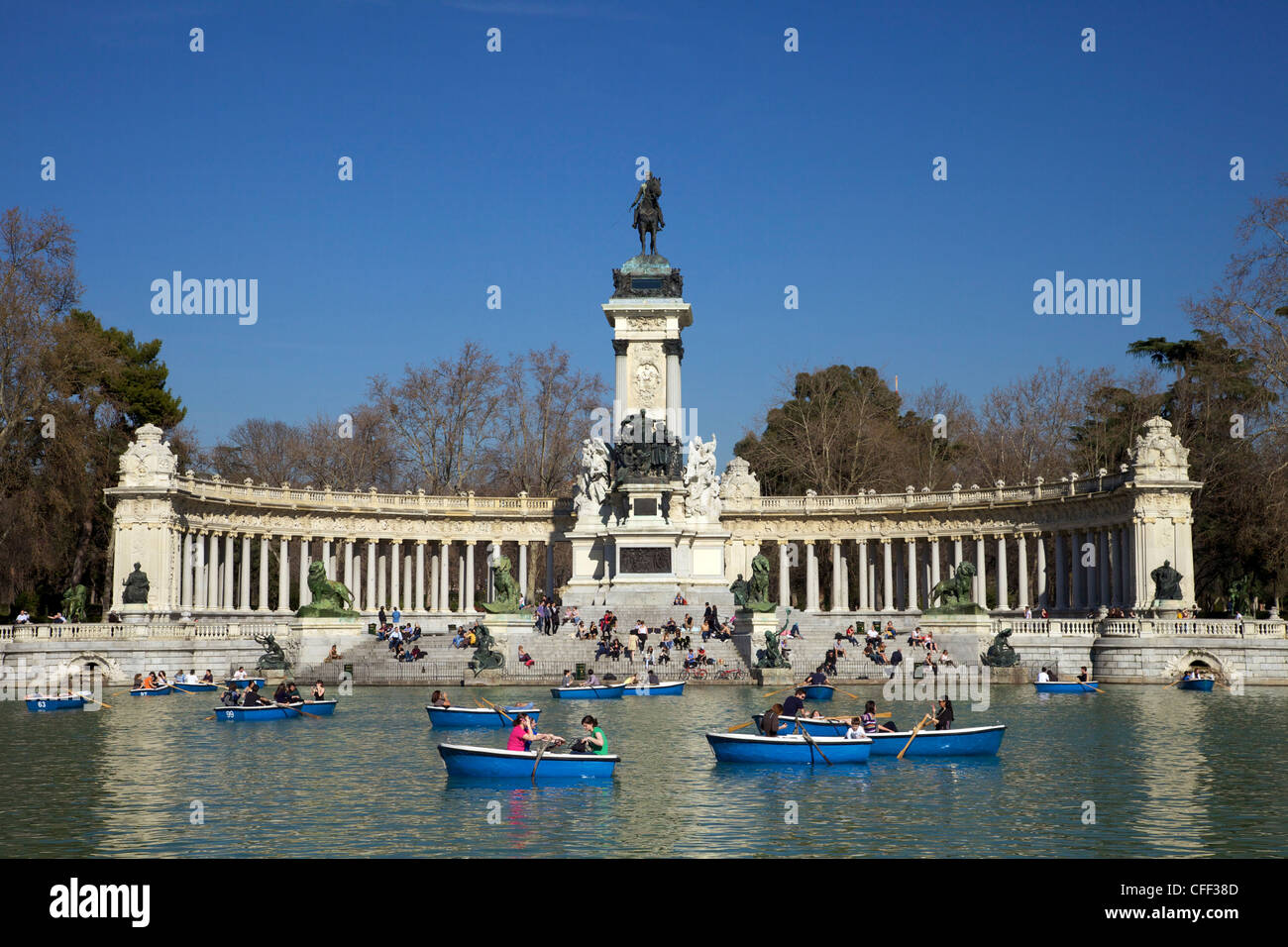 Visitors and tourists enjoy the boating lake in spring sunshine, Retiro ...
