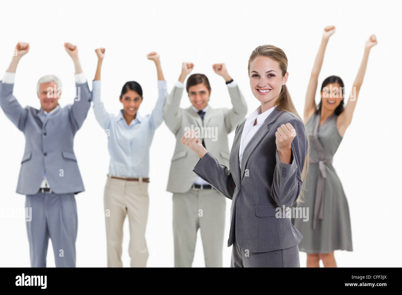 Blonde woman with business people raising their arms behind her Stock ...