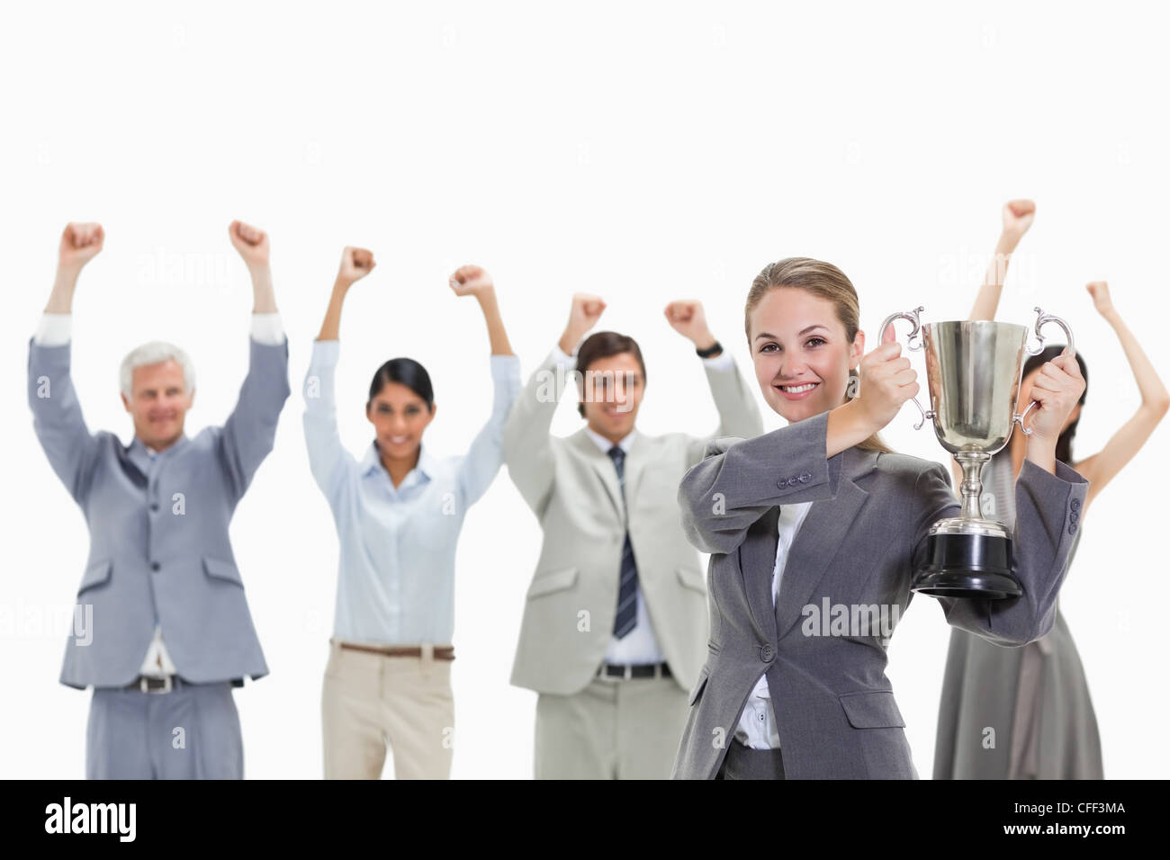 Close-up of a blonde woman raising a cup with enthusiastic business ...
