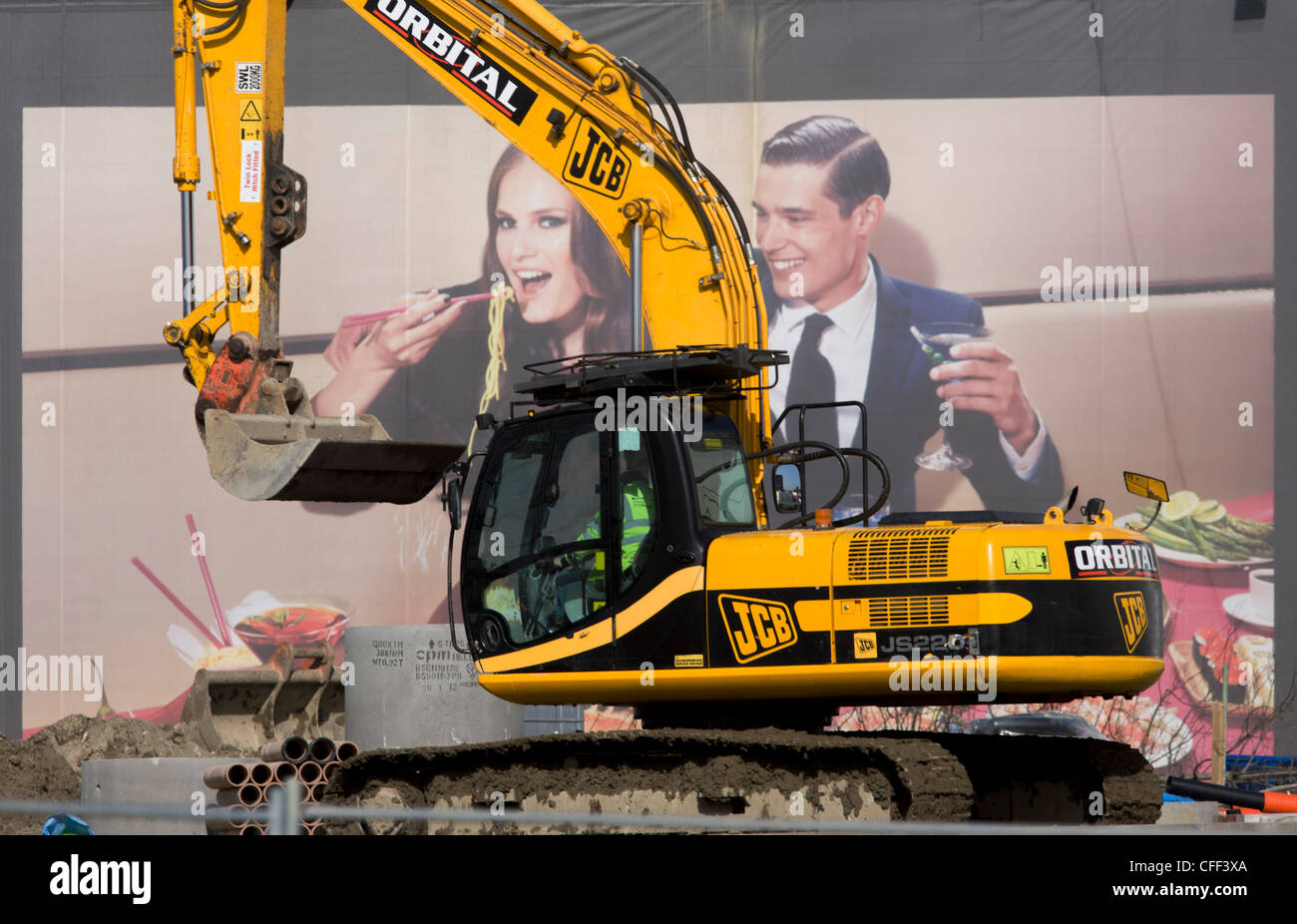 JCB excavator and aspirational poster on wall during building of 2012 ...