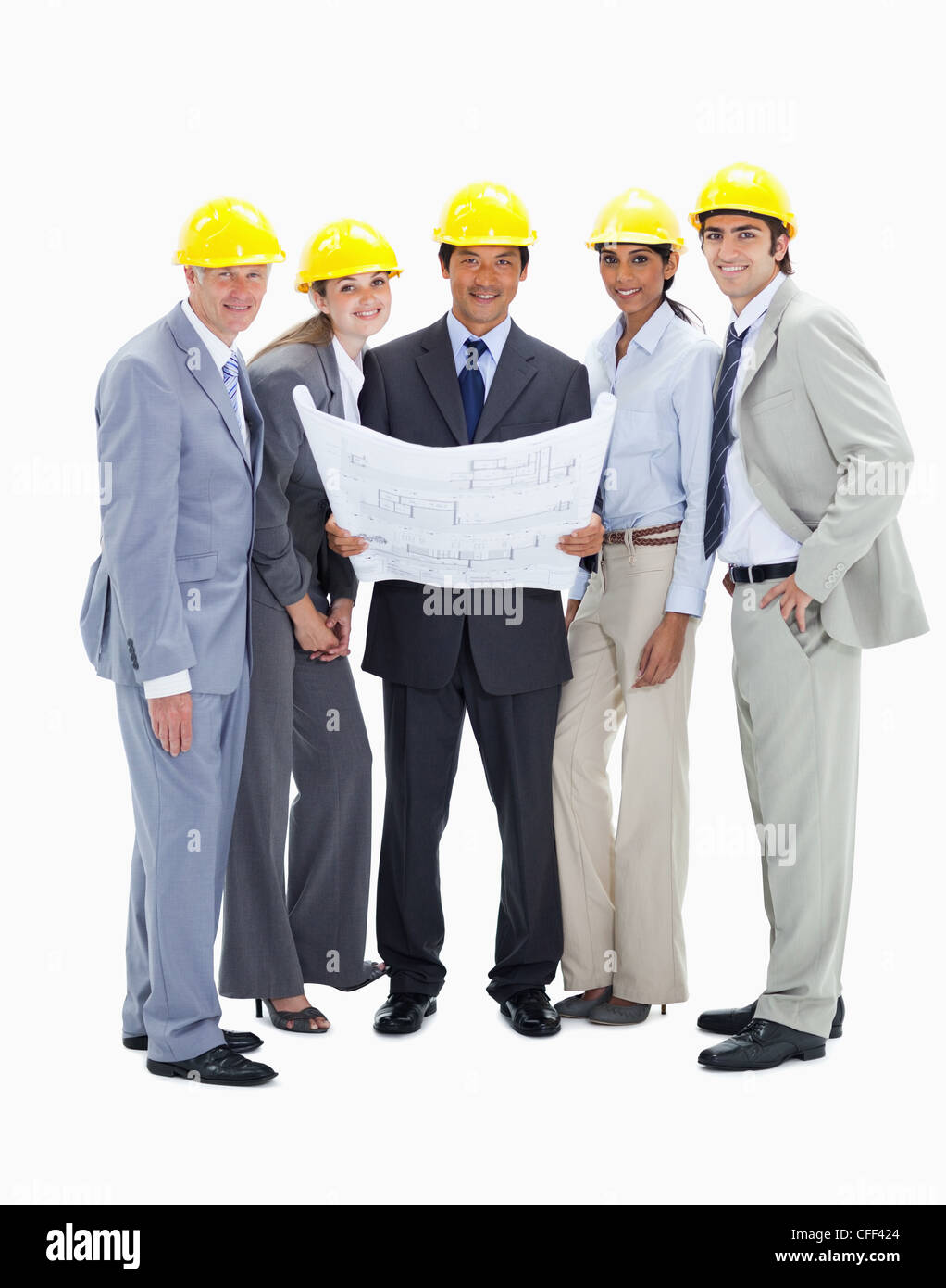 Smiling business people with safety helmets holding construction plans ...