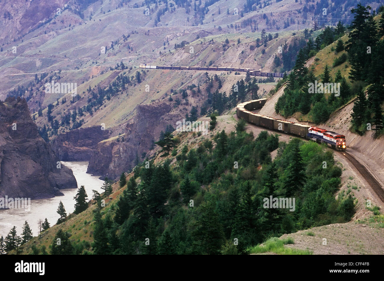 BC Rail freight train travels through central BC above the Fraser River ...