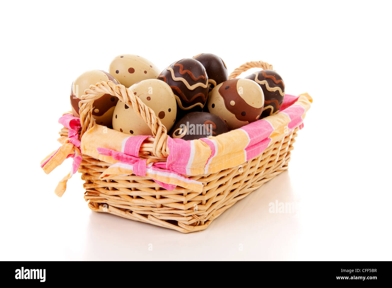 Cane basket with easter eggs over white background Stock Photo - Alamy