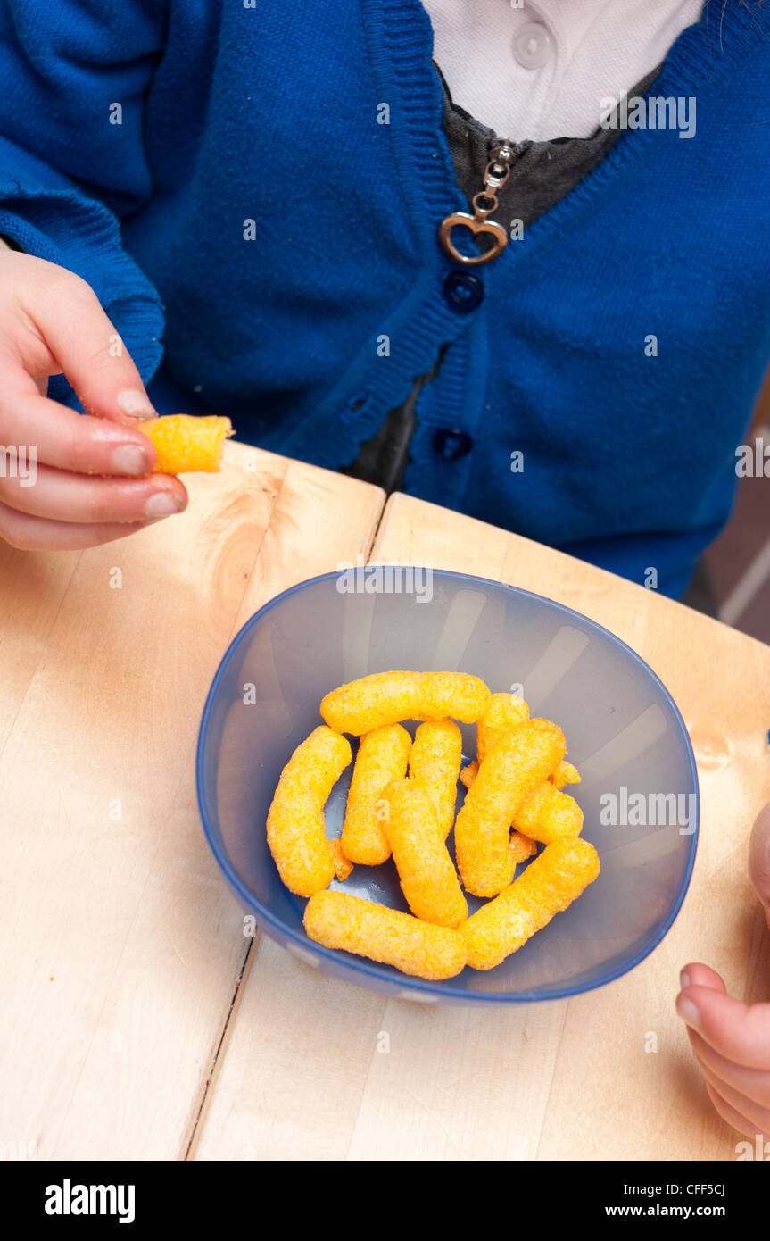 Primary school child eating a snack of crisps Stock Photo - Alamy