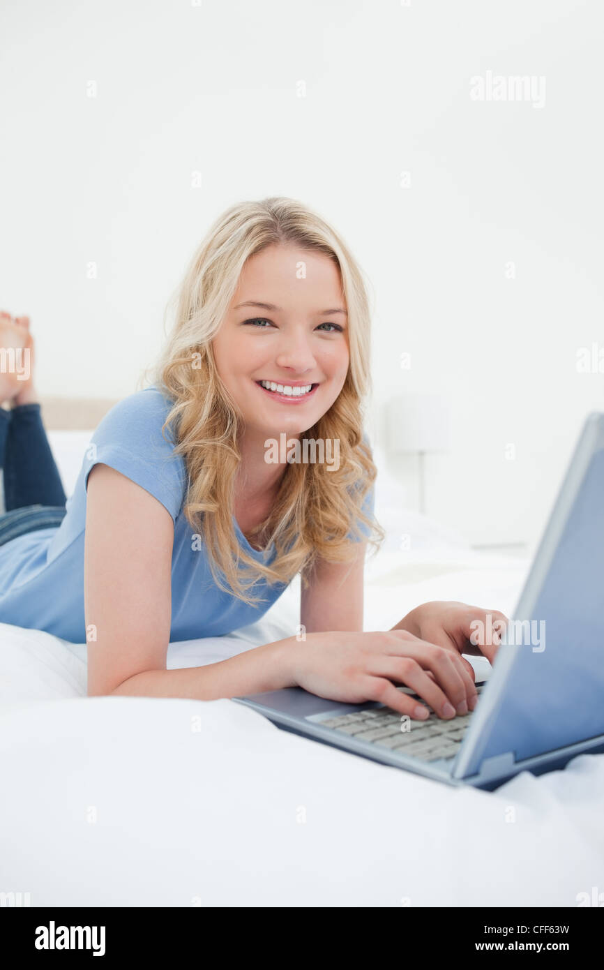 Woman looking forward and smiling, with laptop Stock Photo - Alamy