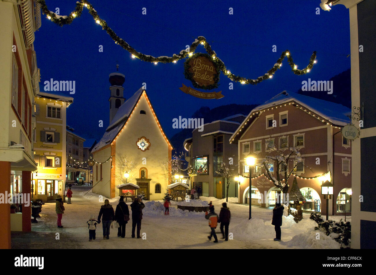 People in snowy street in the evening, Ortisei, Val Gardena, South ...