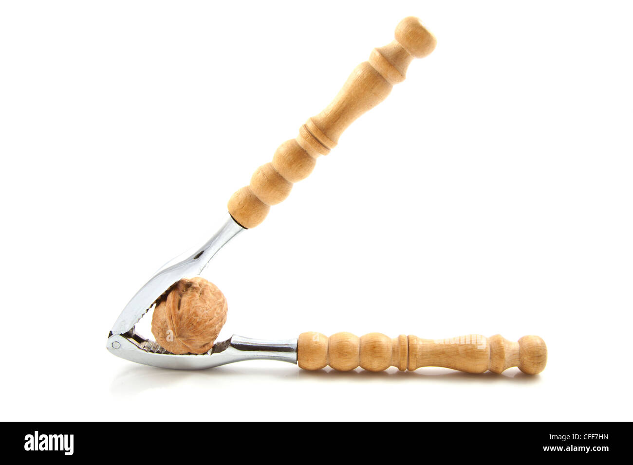 Nut cracker with walnut isolated over white Stock Photo - Alamy