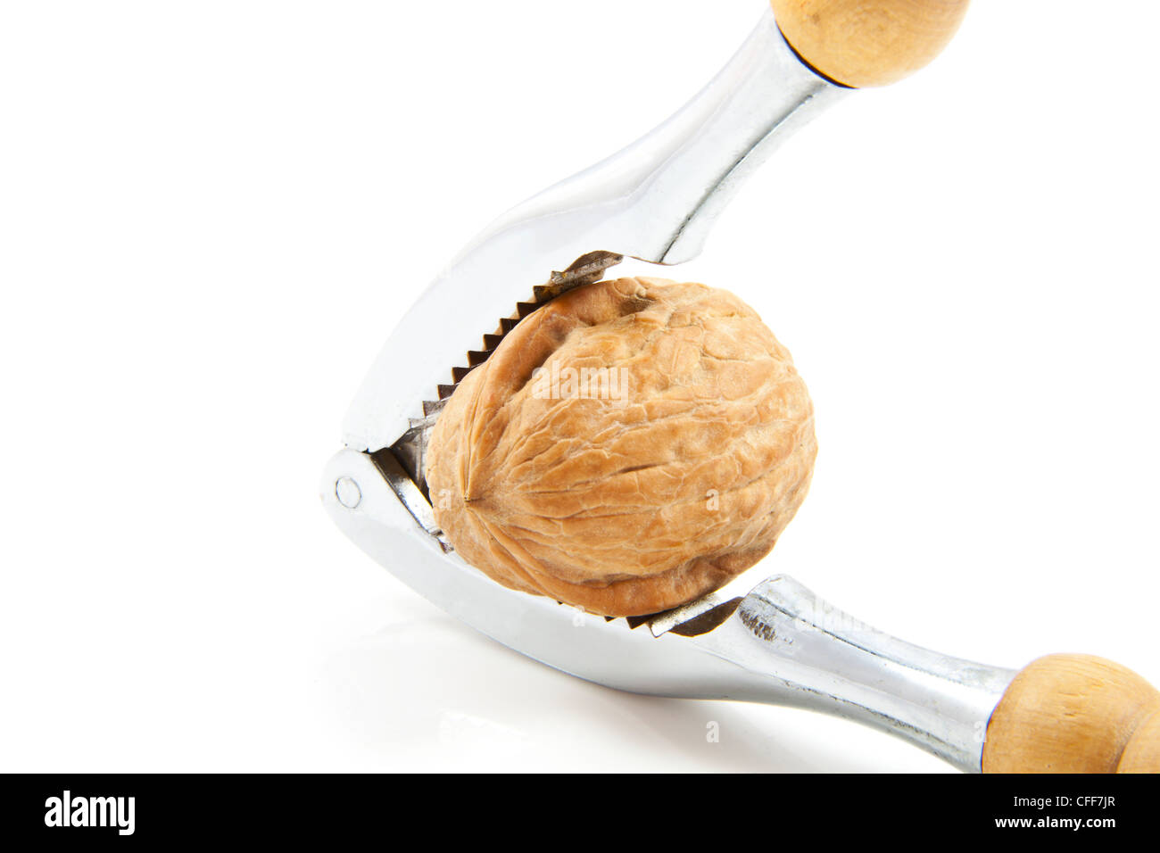 Nut cracker with walnut isolated over white Stock Photo - Alamy