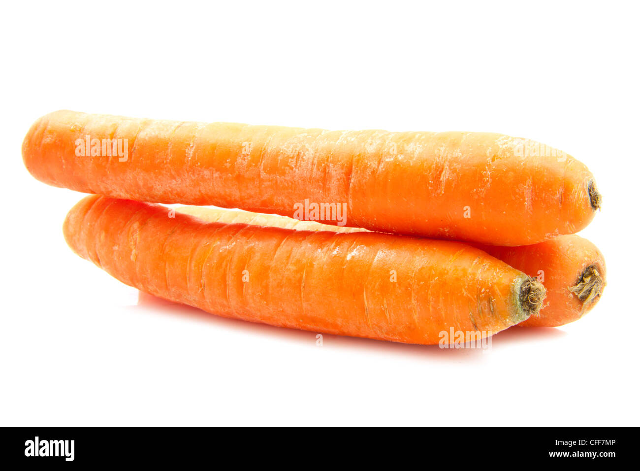 Fresh big carrots on a pile isolated over white Stock Photo - Alamy