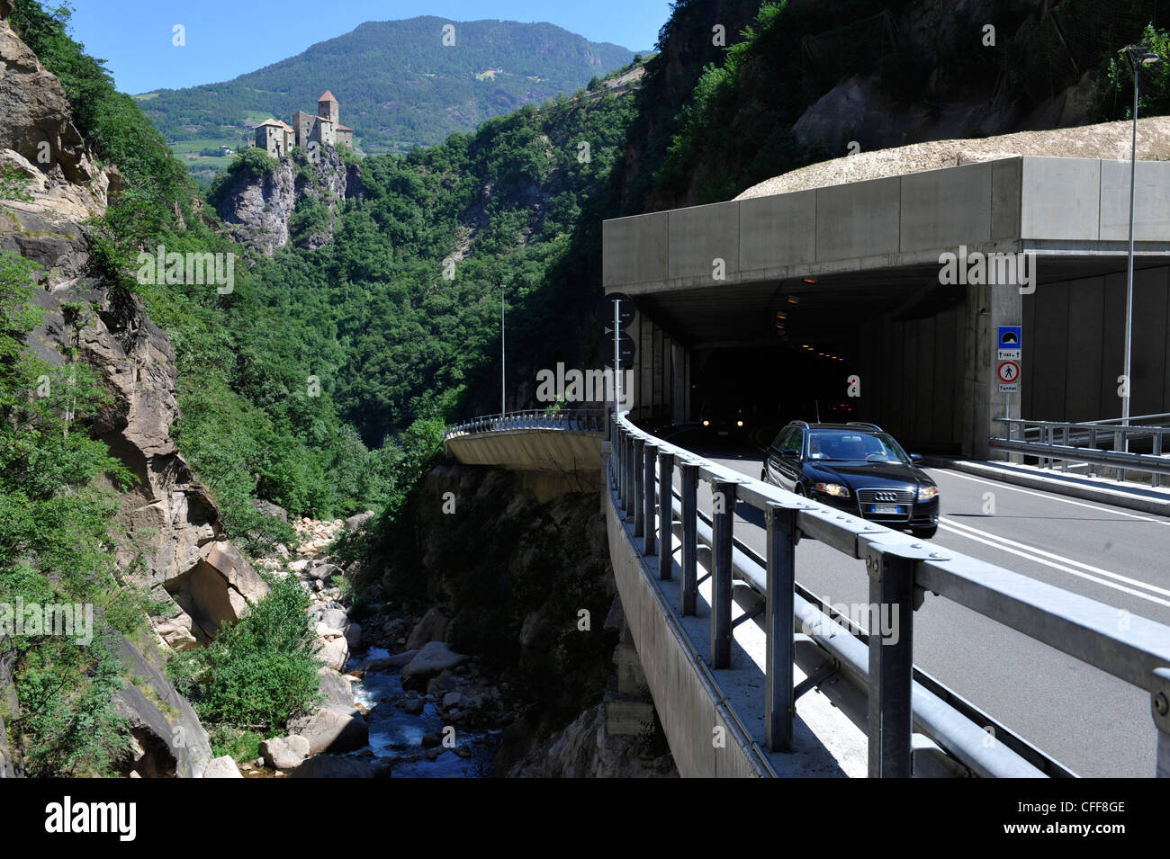 Street and tunnel, Karneid castle in the background, Eggental valley ...