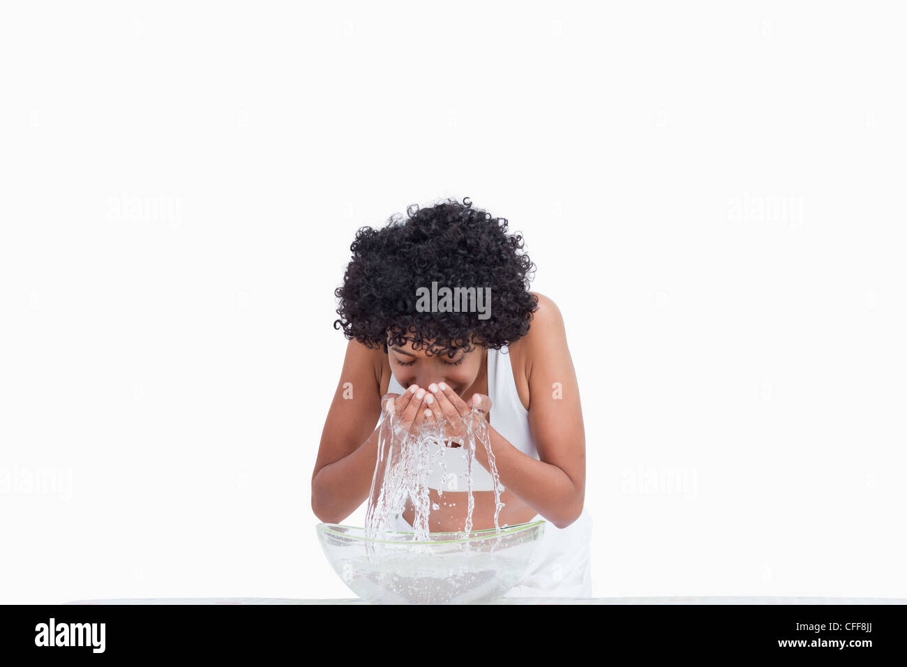 Young woman rinsing her face with water Stock Photo - Alamy