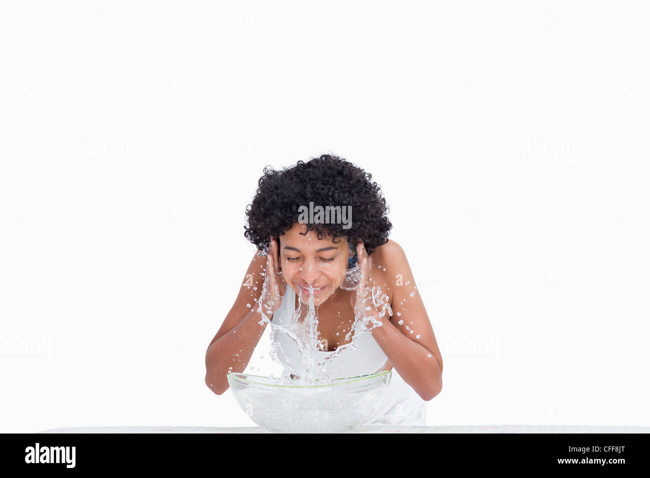 Relaxed young woman splashing her face with water Stock Photo - Alamy
