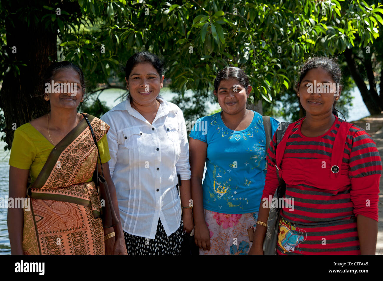 Group of Sri Lankan woman smile for the camera whilst taking a stroll ...