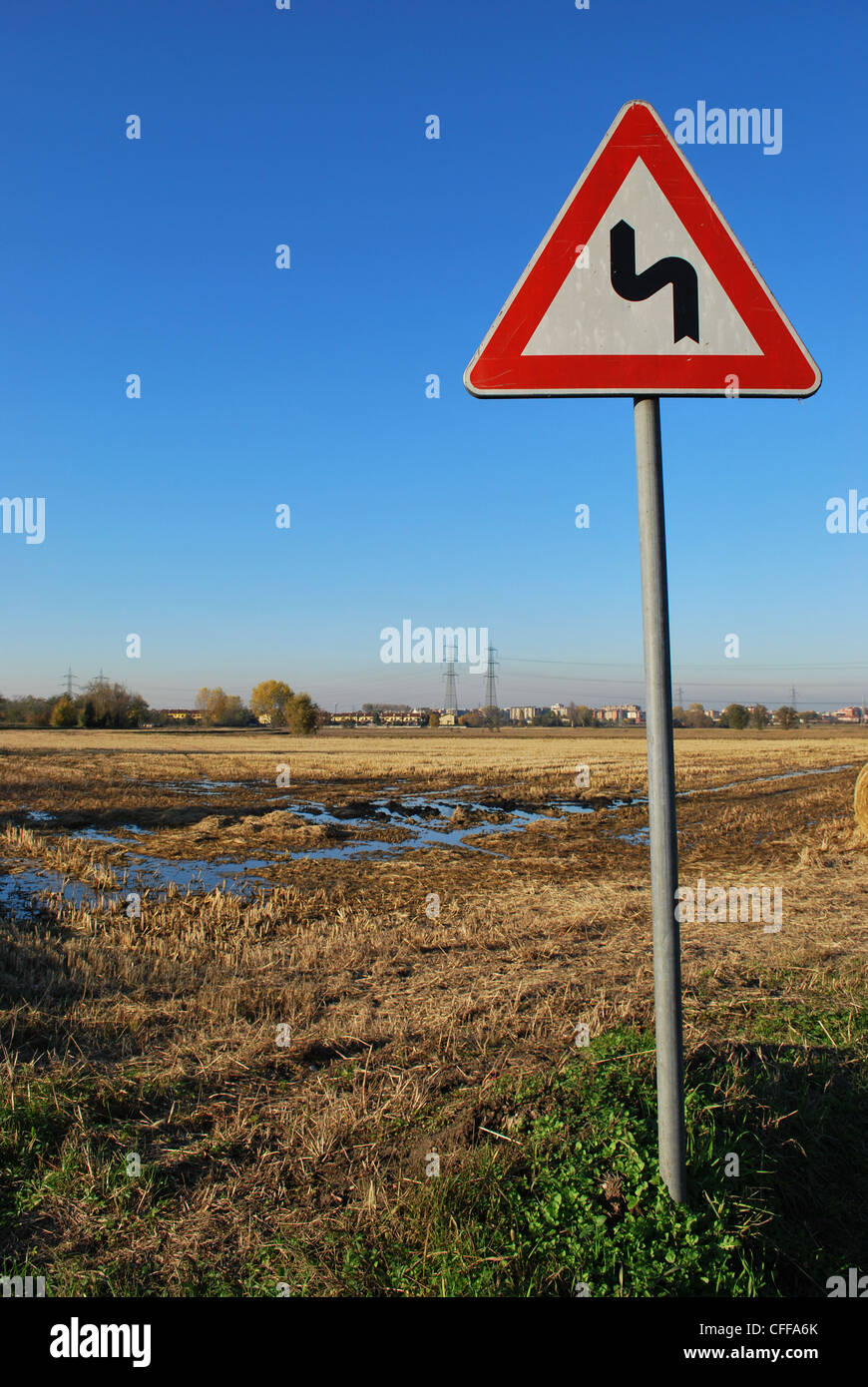 Curves sign in Po valley landscape near Milan in a sunny day in winter ...