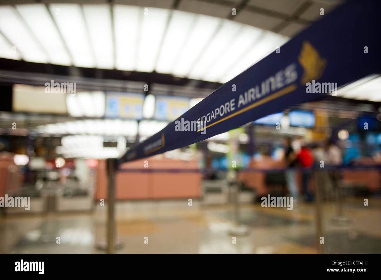 Passengers check-in for their Singapore Airlines Ltd. flight at Changi ...