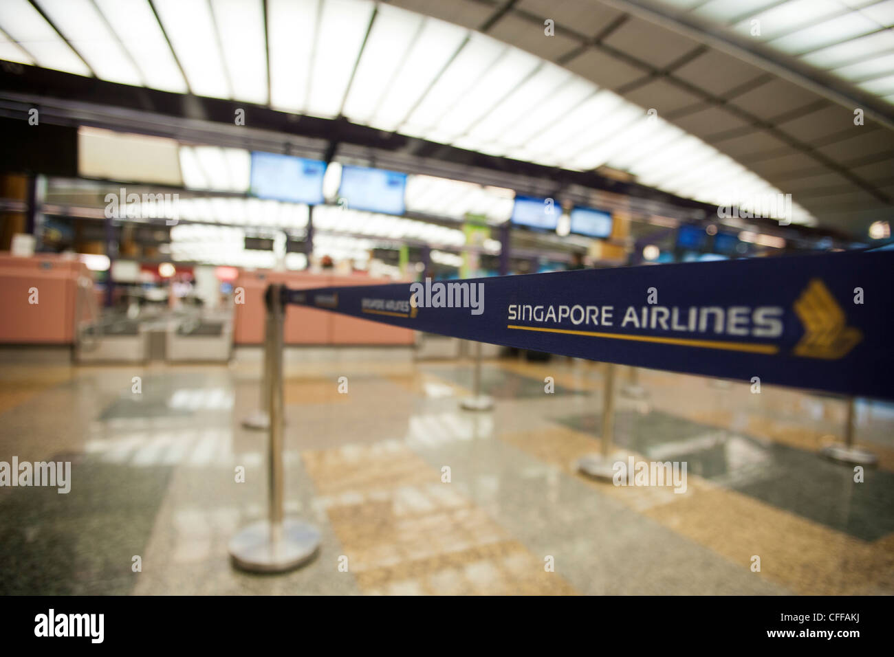 Passengers check-in for their Singapore Airlines Ltd. flight at Changi ...