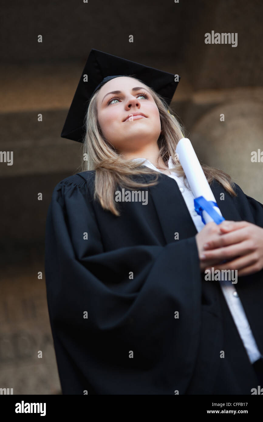 Low-angle view of a graduating student wearing a gown Stock Photo - Alamy