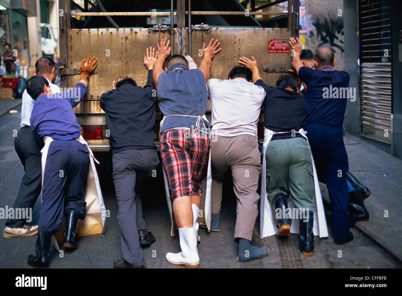 China, Hong Kong, Central, Street Scene, Men pushing broken down truck ...