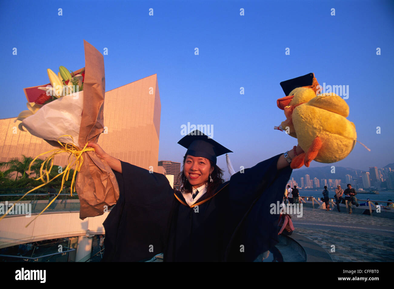 China, Hong Kong, Kowloon, Tsim Sha Tsui, Girl Celebrating Graduation ...